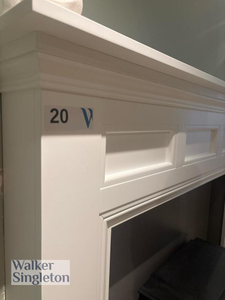 Traditional White fireplace surround with a tiered mantel and recessed ...